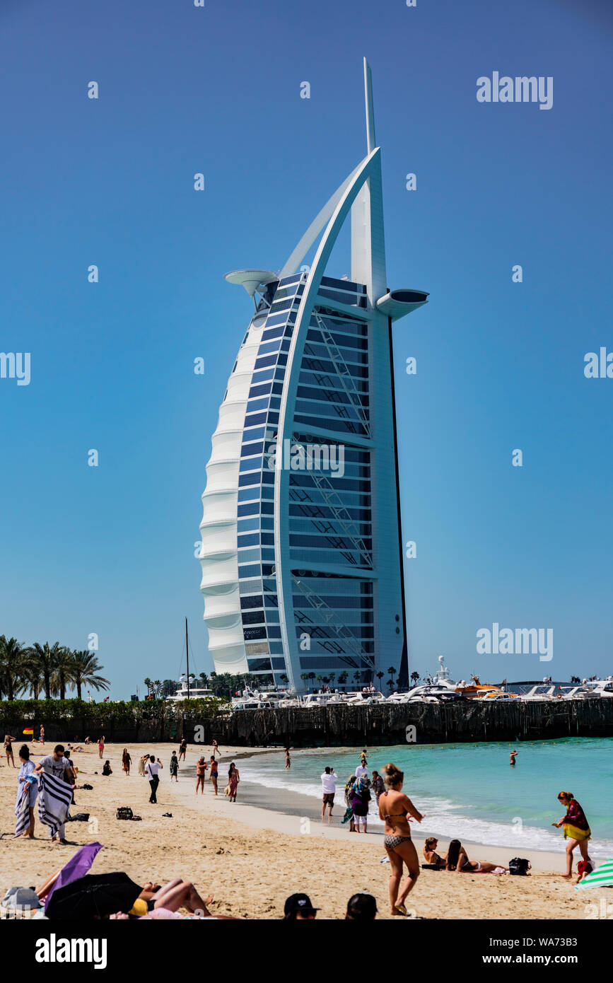 DUBAI, UAE, MAR 20, 2018: Skyscraper shaped like a sail on the beach ...