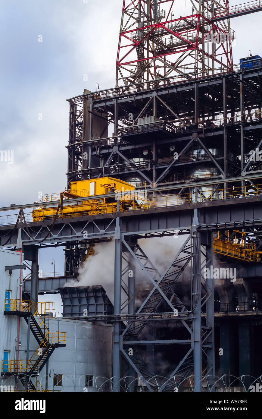 industrial background - fragment of delayed coking unit against the sky ...