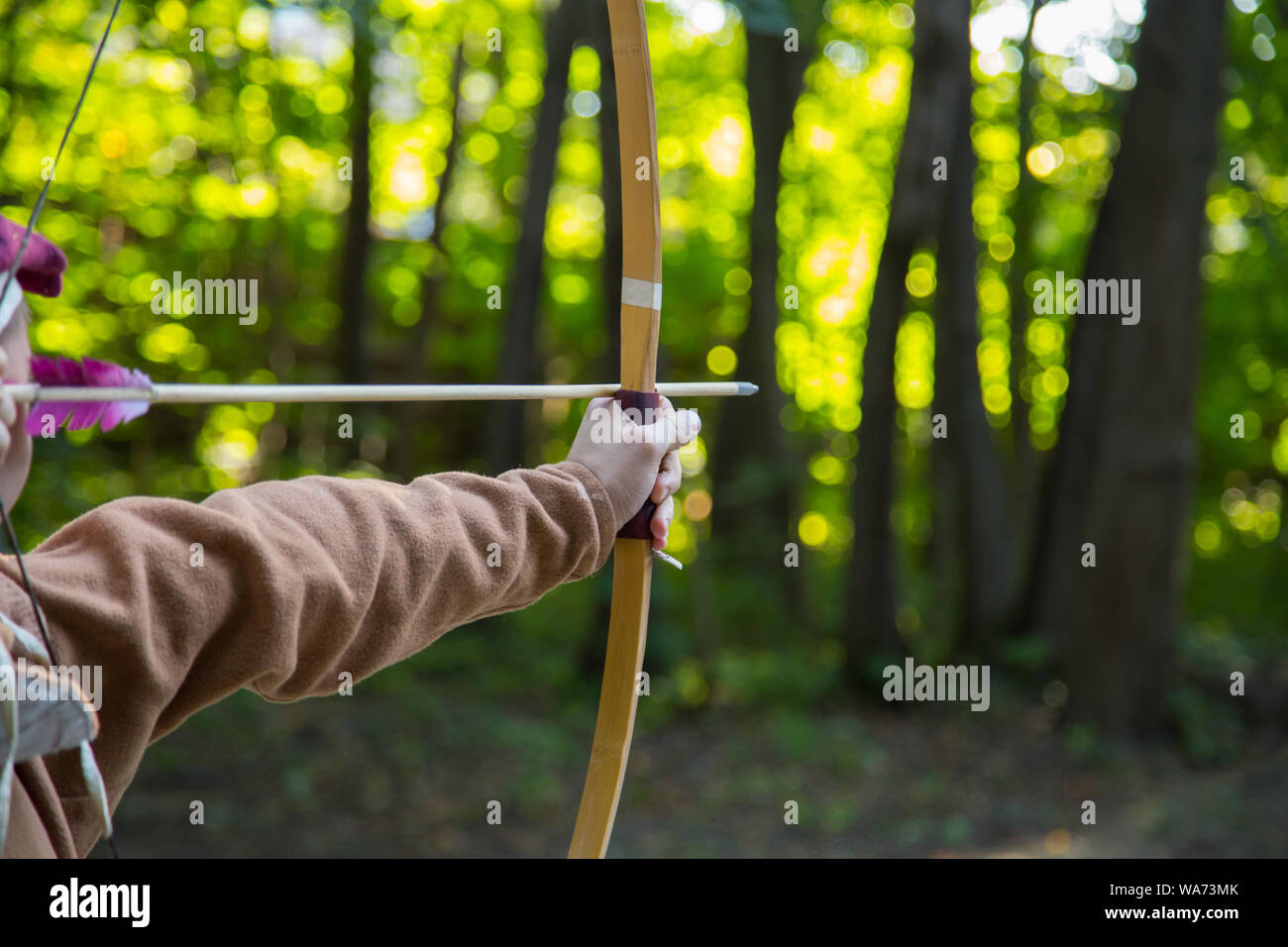 Male archer with wooden bow Stock Photo - Alamy