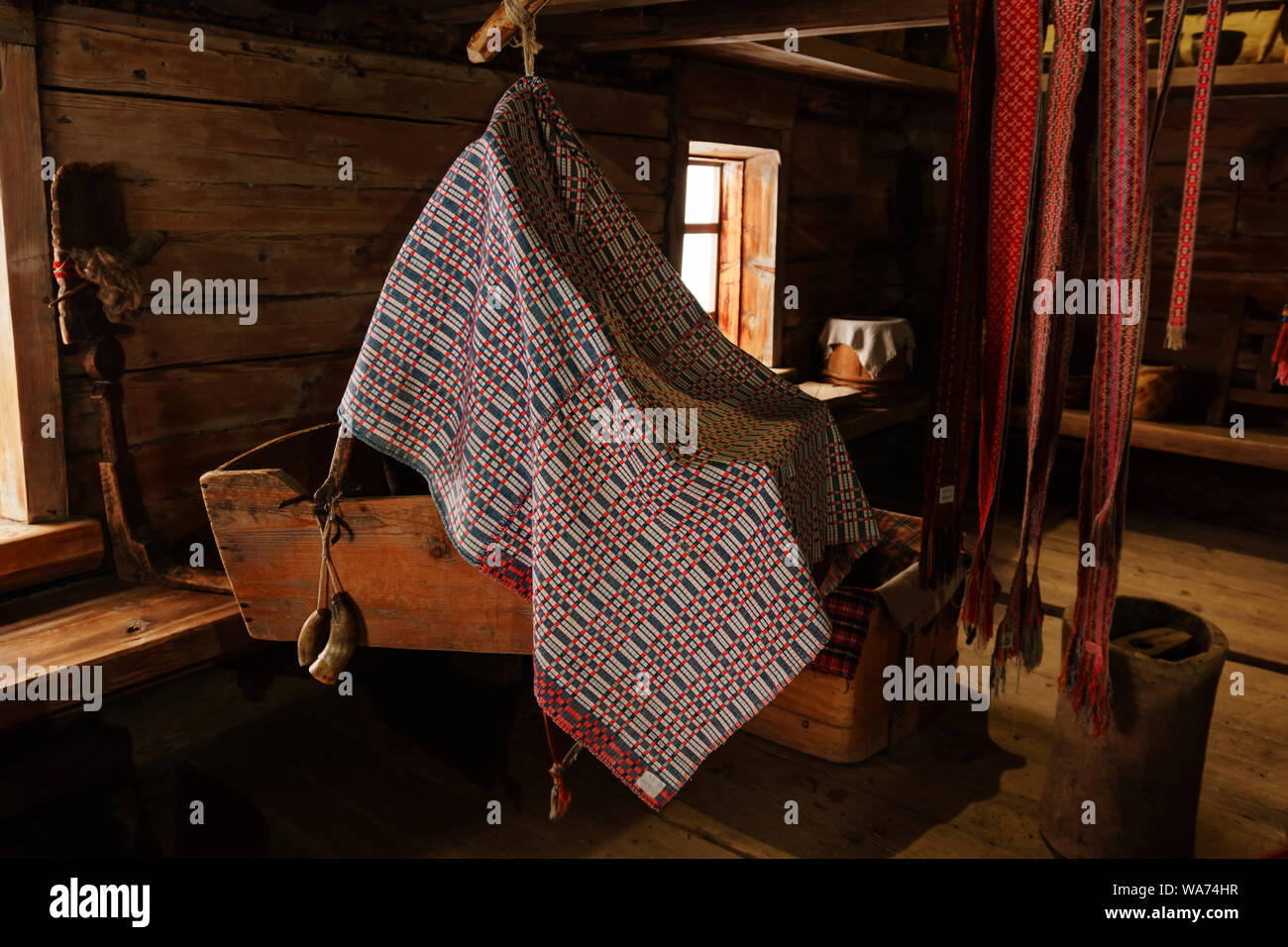 fragment of the interior of an old peasant log cabin with a cradle ...
