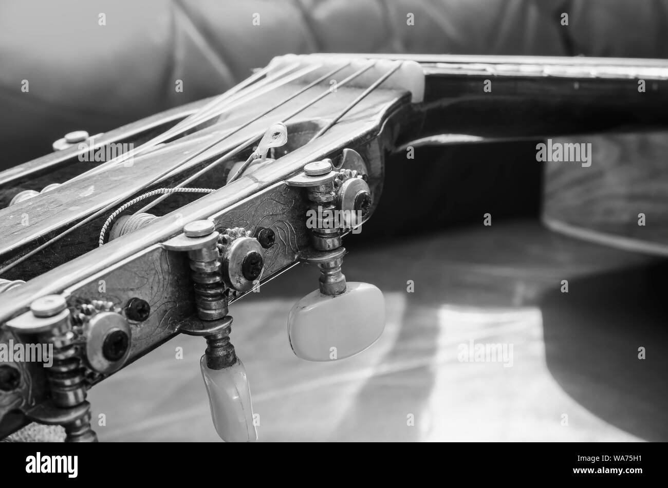 Tuning pegs and gears of the headstock of an acoustic guitar. Details ...