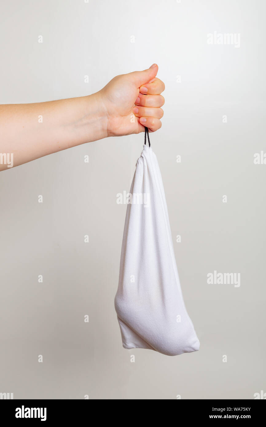 Female hand hold reusable cloth bag of fruit. Sustainable lifestyle ...
