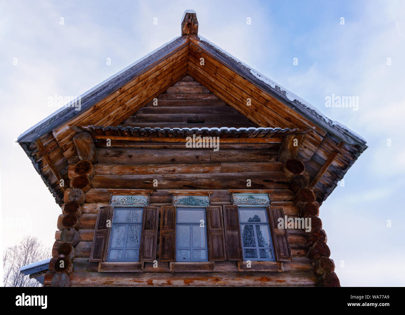 old log Russian peasant hut izba, facade with three windows against the ...