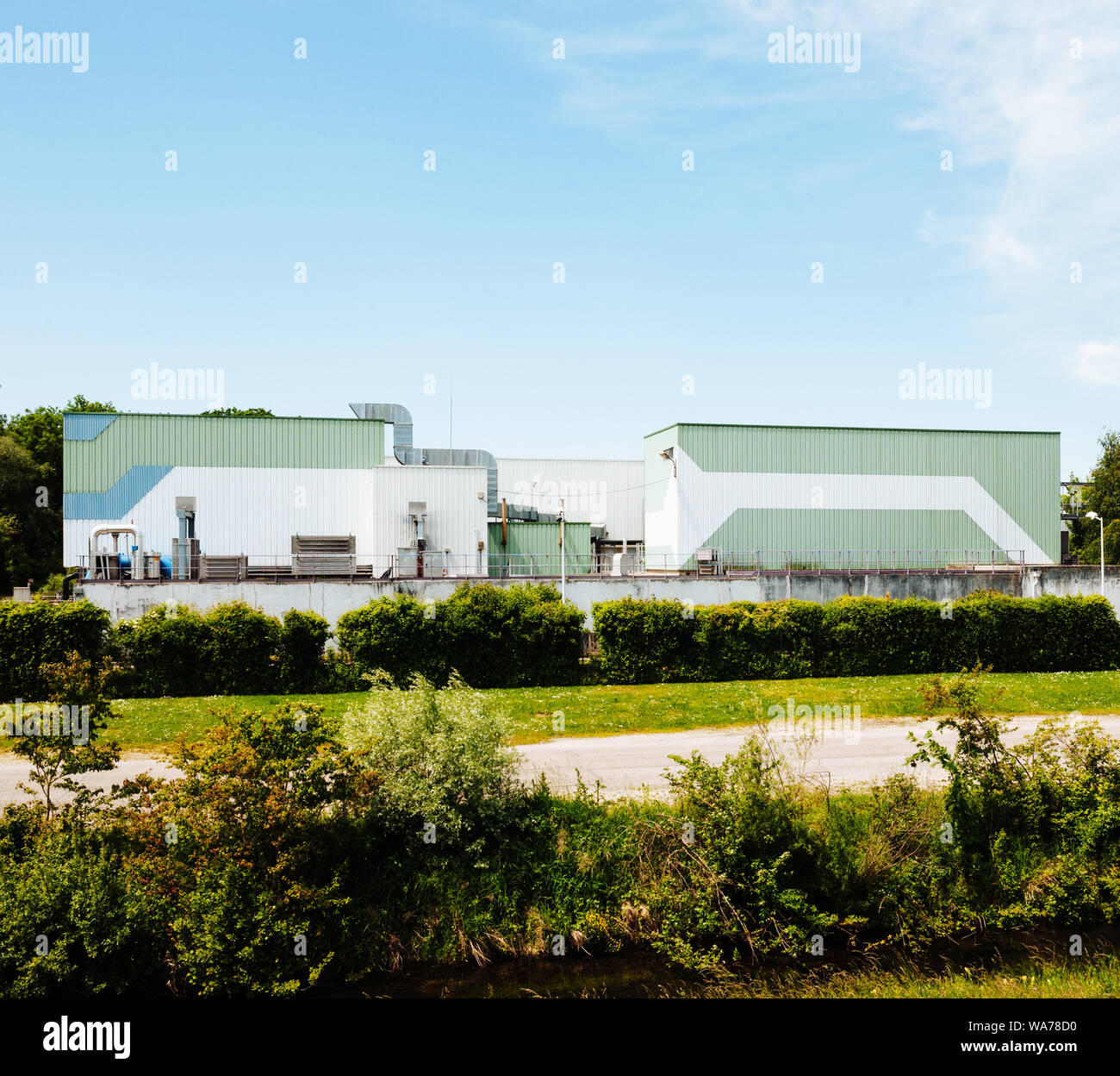 Square image of abandoned factory in the middle of the forest with ...