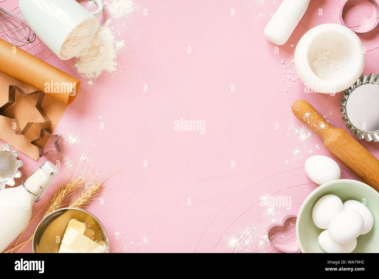 Pink background with raw ingredients for baking, traditional cookies or ...