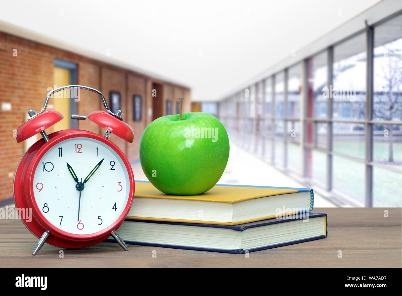 very blurry empty college hall as background with book for education ...