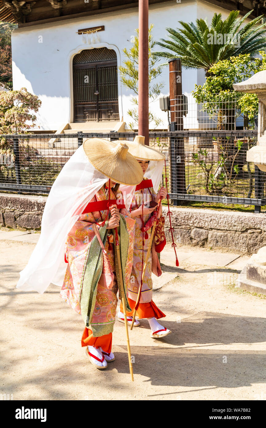 Japan, Miyajima Island. Two Japanese women in Tsubo Shozoku costumes ...