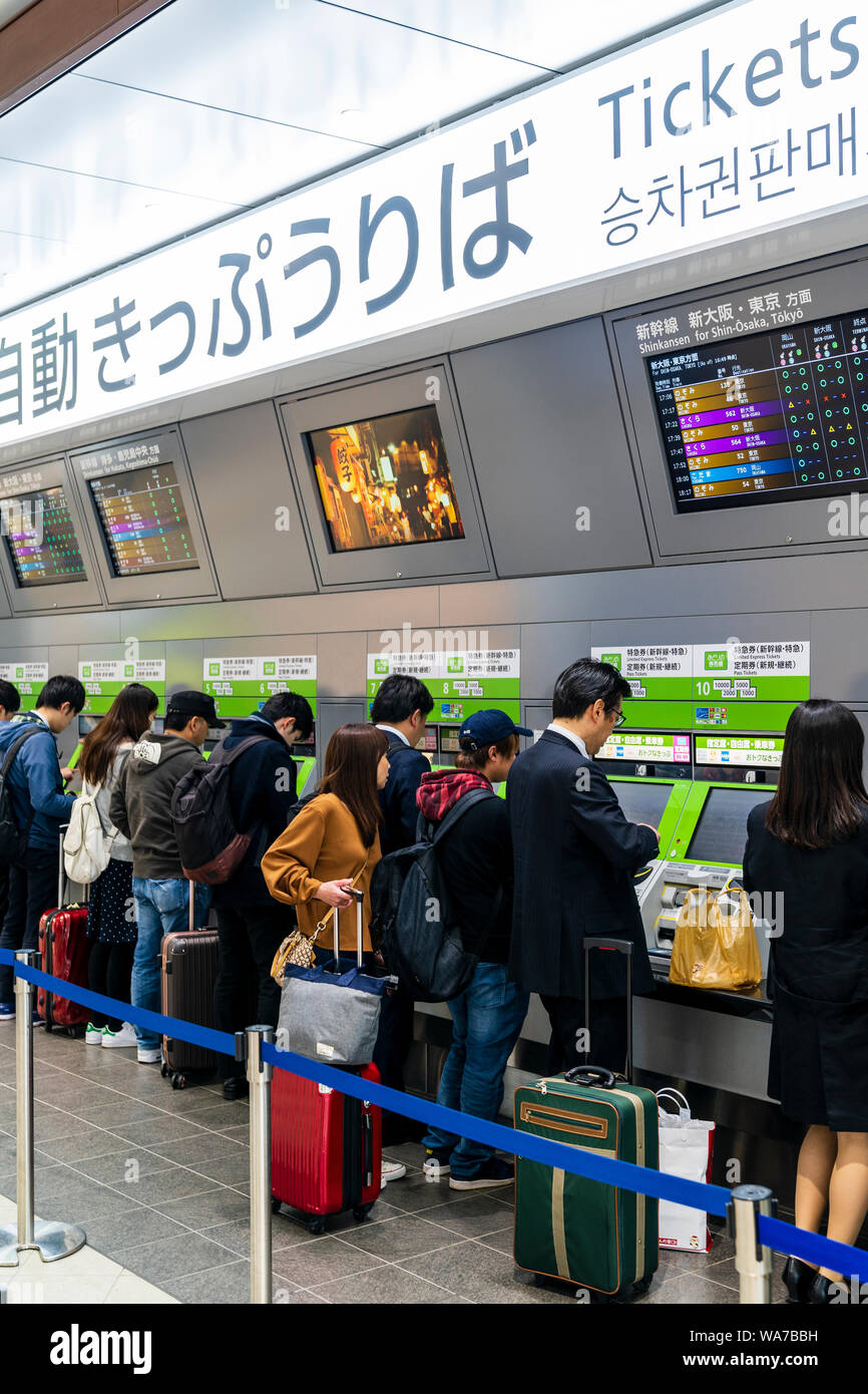 Japan, Hiroshima station interior. People in line to buy from ...