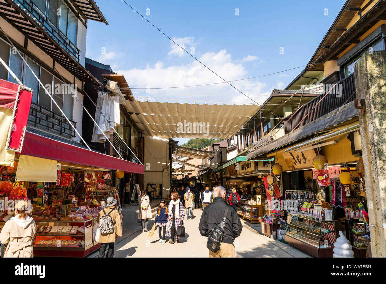Japan, Miyajima. View along main street with typical tourist shops and ...