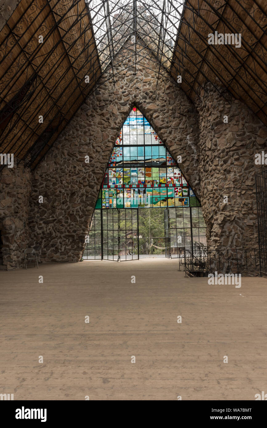 An arched window with a mountain view inside Bishop's Castle, a most ...