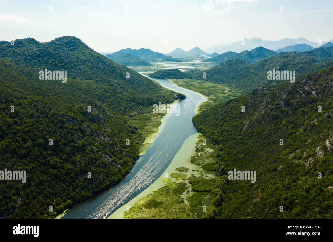 Aerial view of river Crnojevica leading to lake Skadar through a mountainous landscape. Lake ...