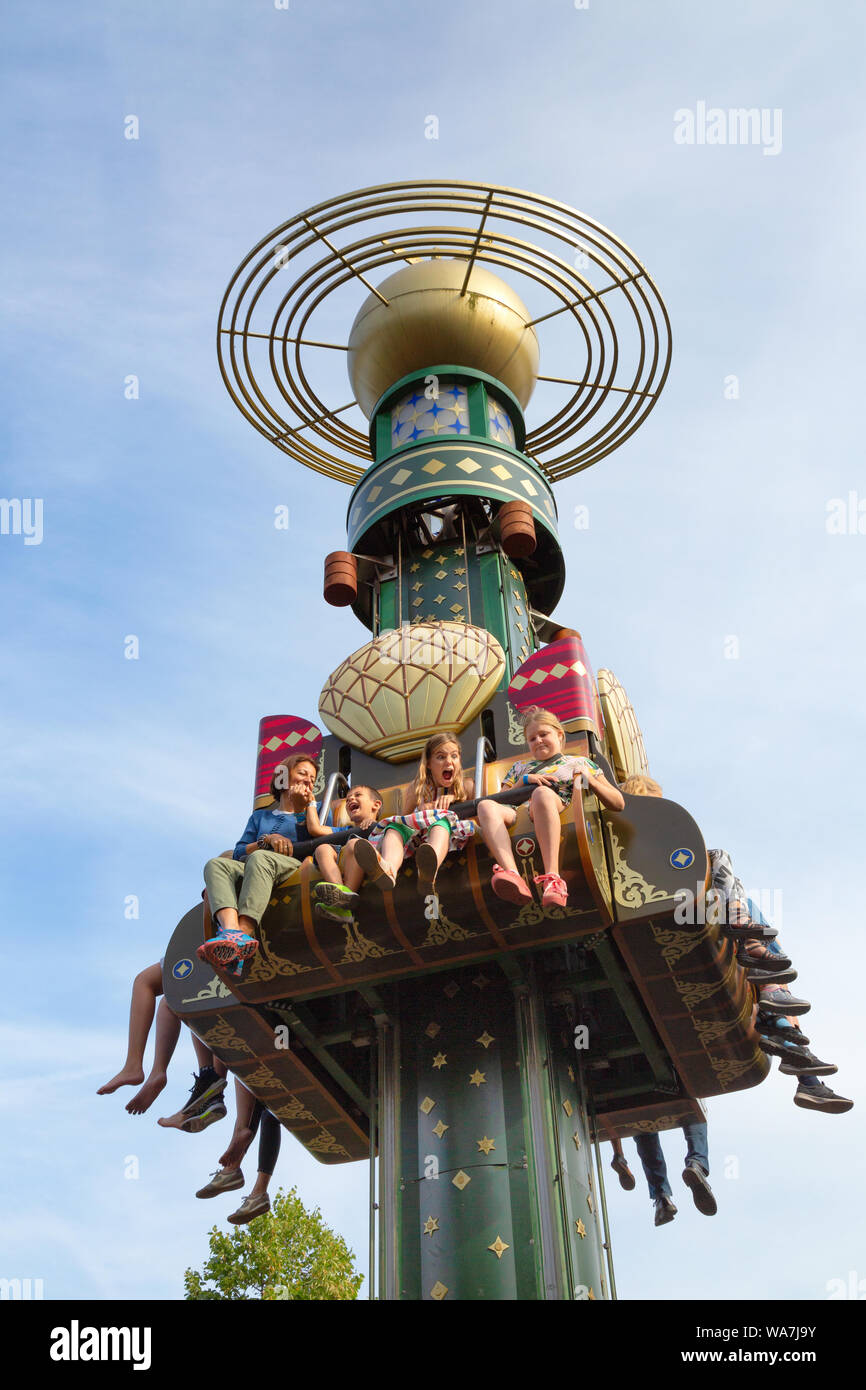 Fairground children; kids having fun on a fairground ride; Tivoli ...