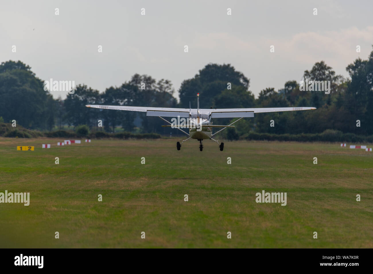 a landing plane on a small airfield Stock Photo - Alamy