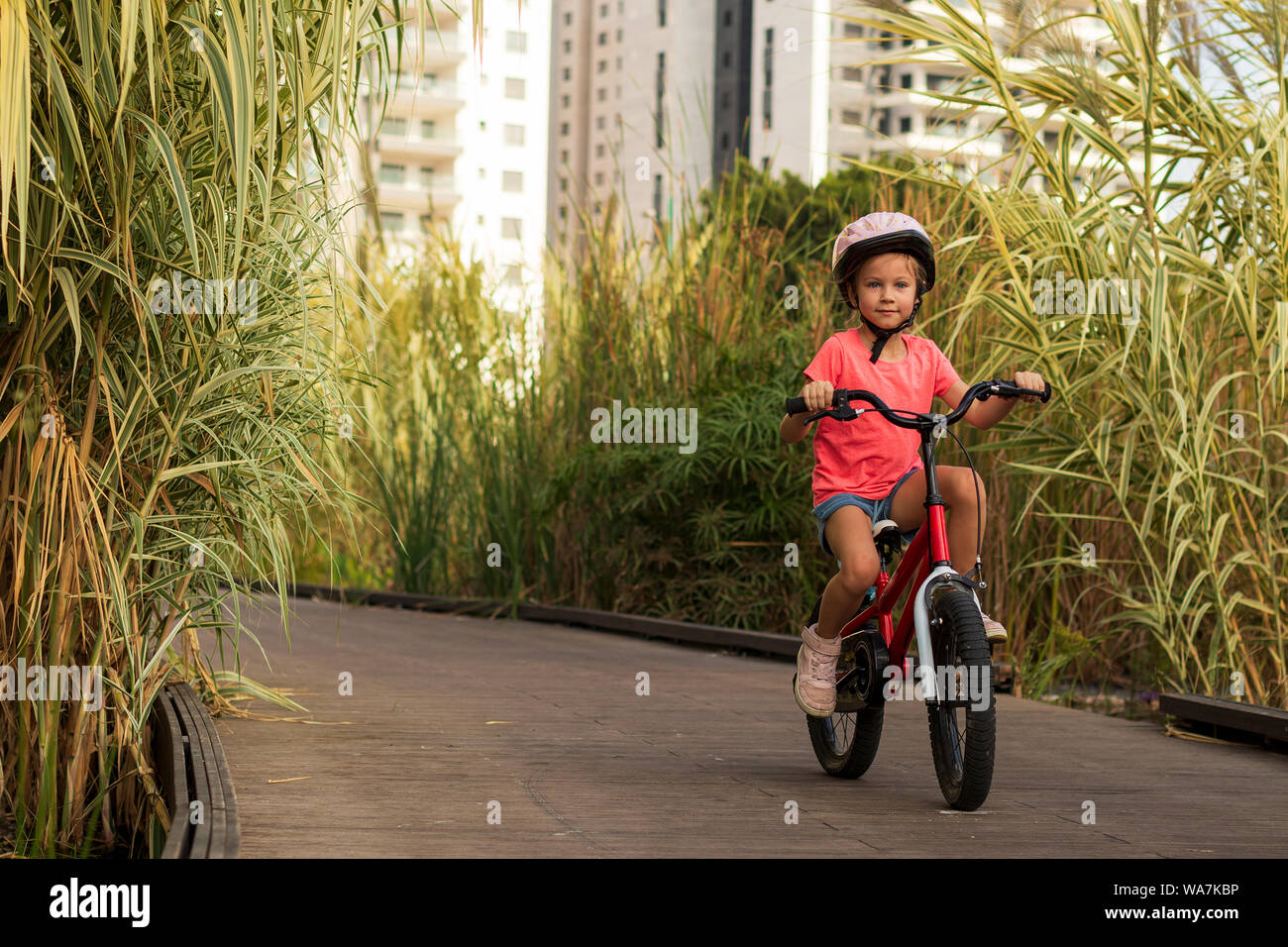 Child learning to cycle hi-res stock photography and images - Alamy