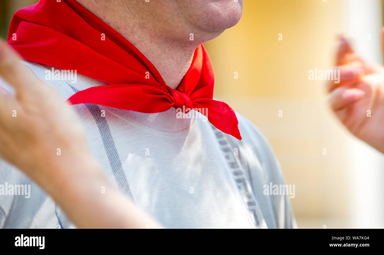Woman ties red silk neckerchief to a man Stock Photo - Alamy