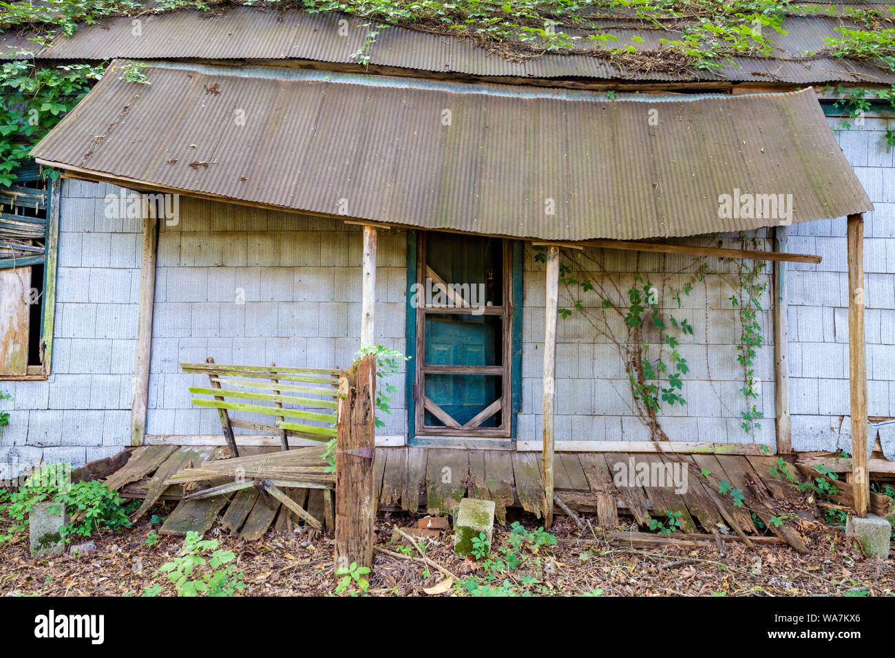 Roof falling over the front porch of an old home Stock Photo - Alamy