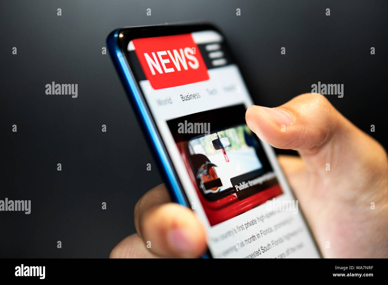 A man holding mobile smart phone with news on screen. Newspaper online ...