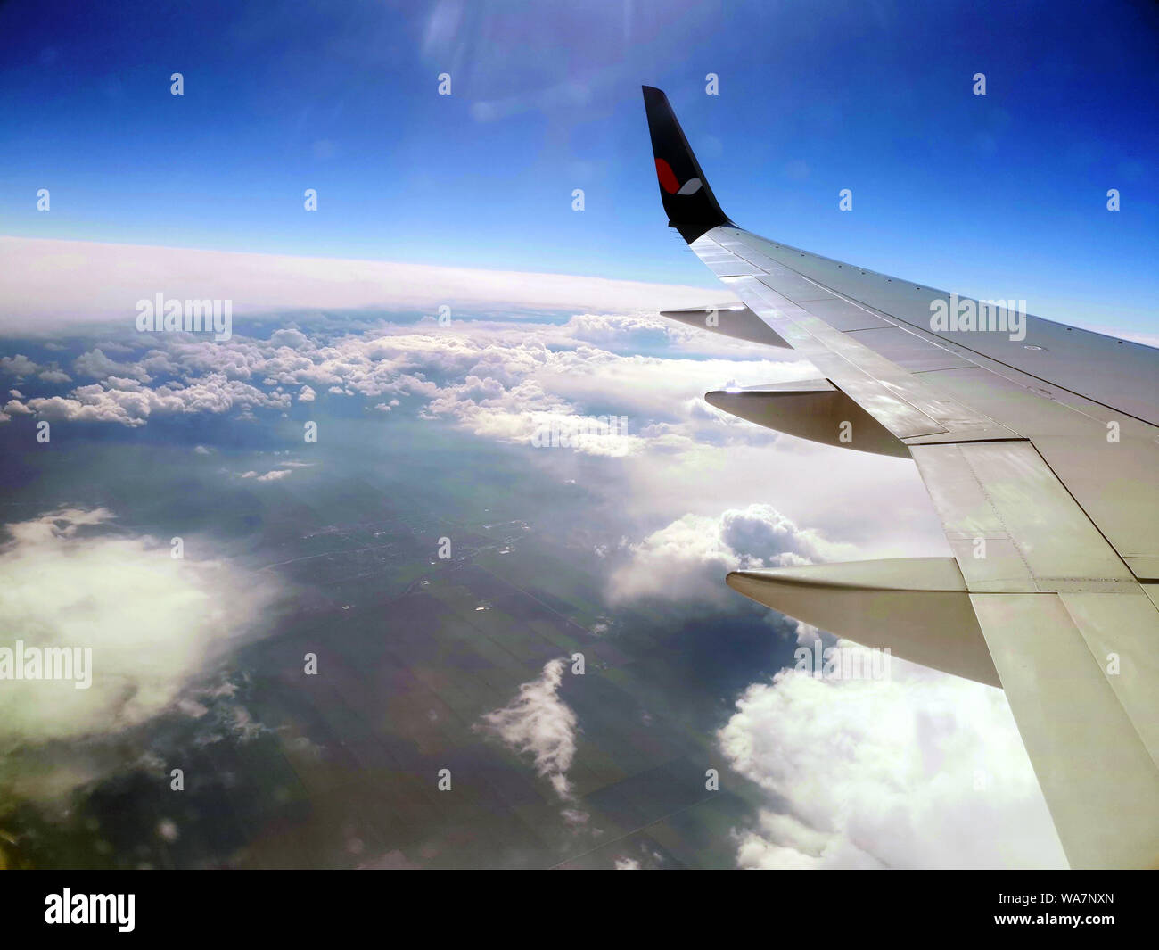 View from airplane window on the wing, clouds and sky Stock Photo - Alamy