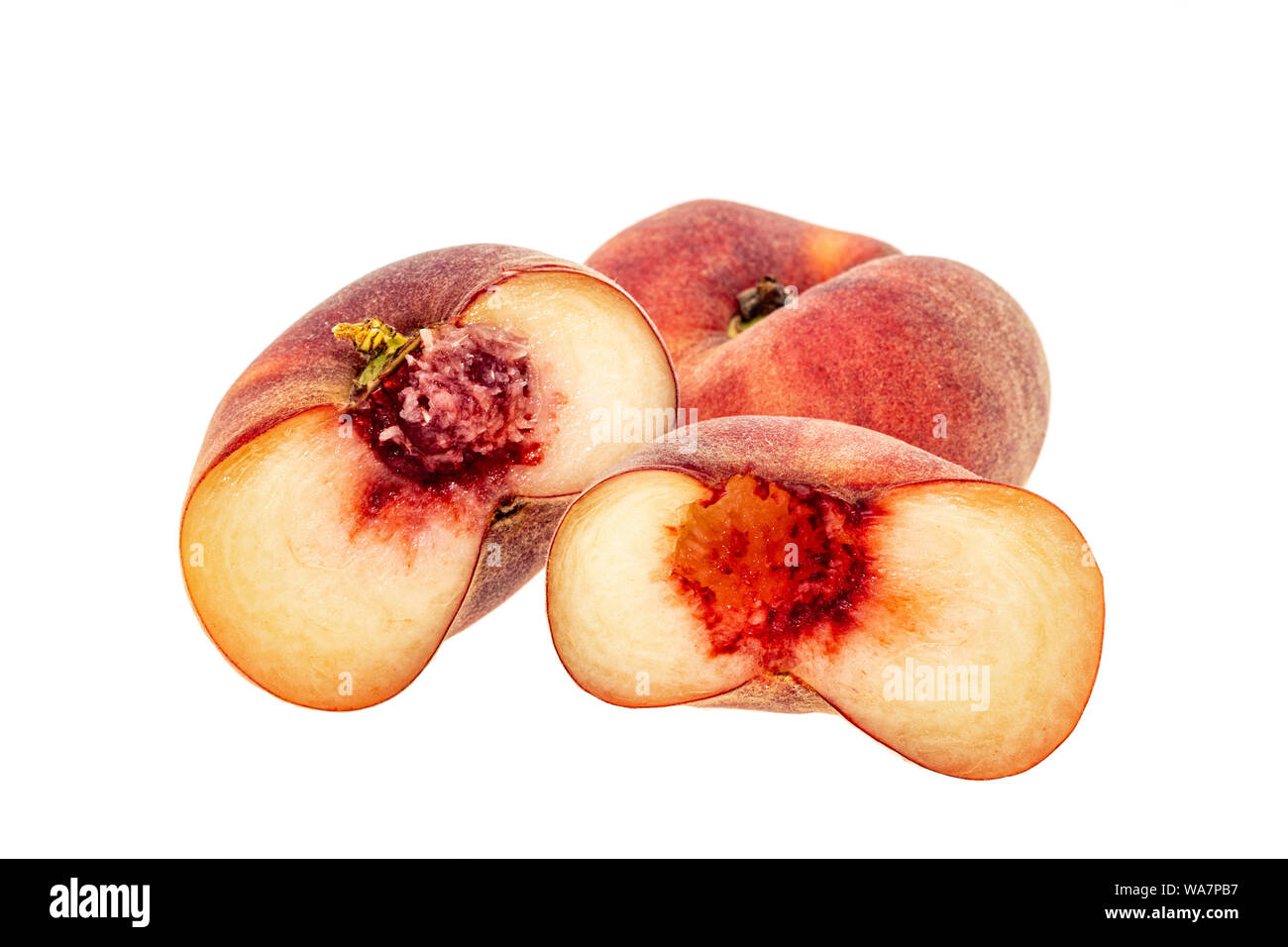 Flat peach with one cut open - white background Stock Photo - Alamy