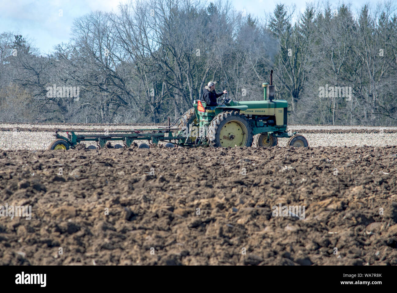 april 28 2018 Buchanan MI USA; tractor plowing a farm field during a ...