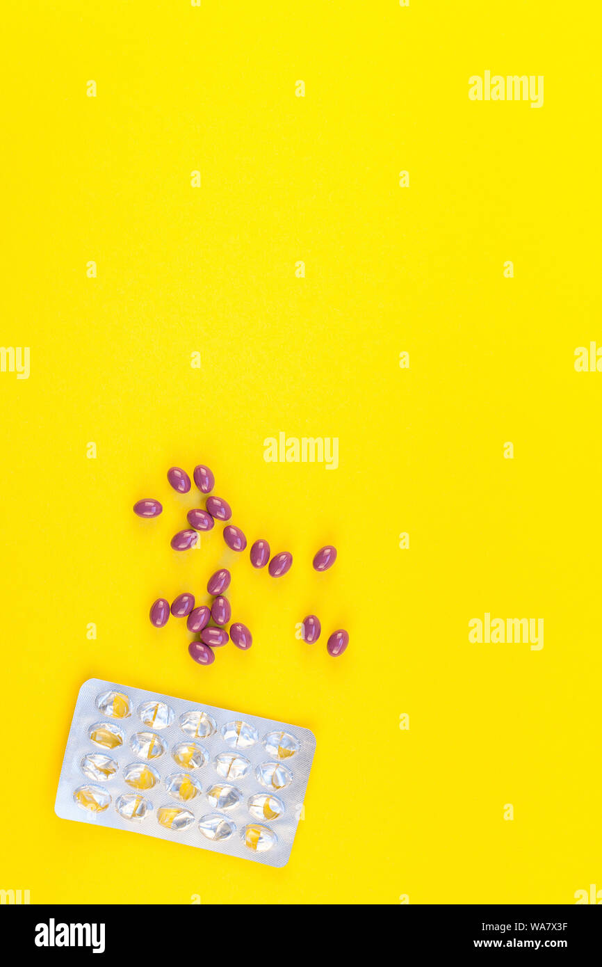 Nutritional supplement purple pills with empty blisters isolated on ...