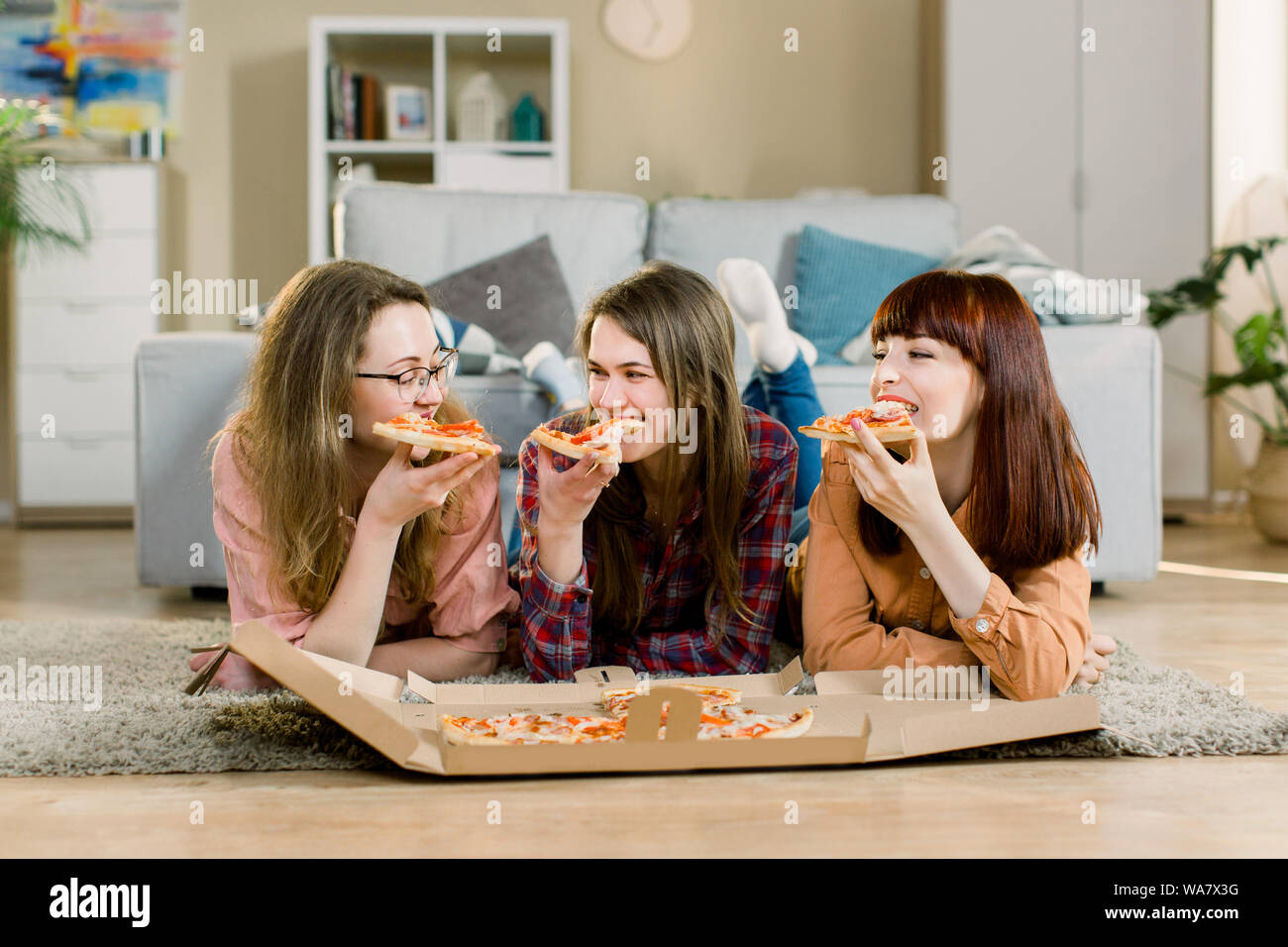 Eating Fast Food. Happy three Beautiful Friends Laughing, Eating Pizza ...