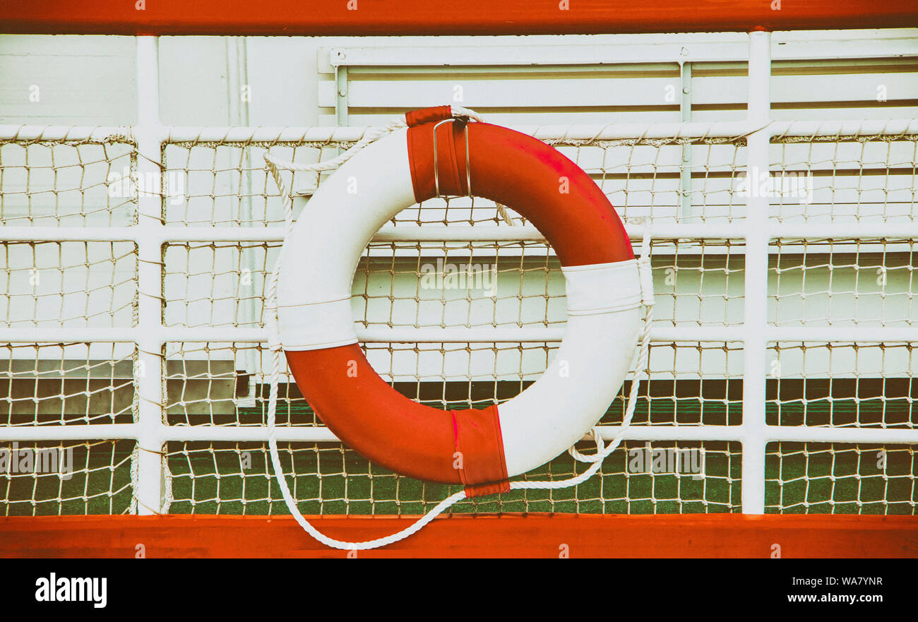 Vintage background with rescue circle on boat. Lifebuoy is mounted on a ...