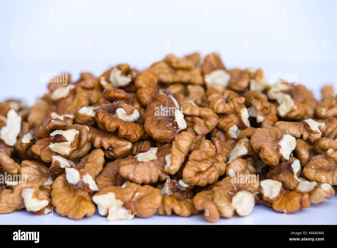 Walnuts whole and nuts on white background Stock Photo - Alamy