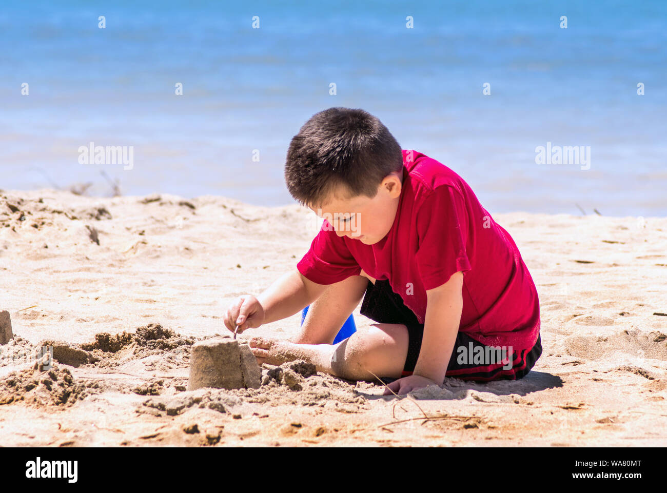 Boy building sandcastle on beach hi-res stock photography and images ...