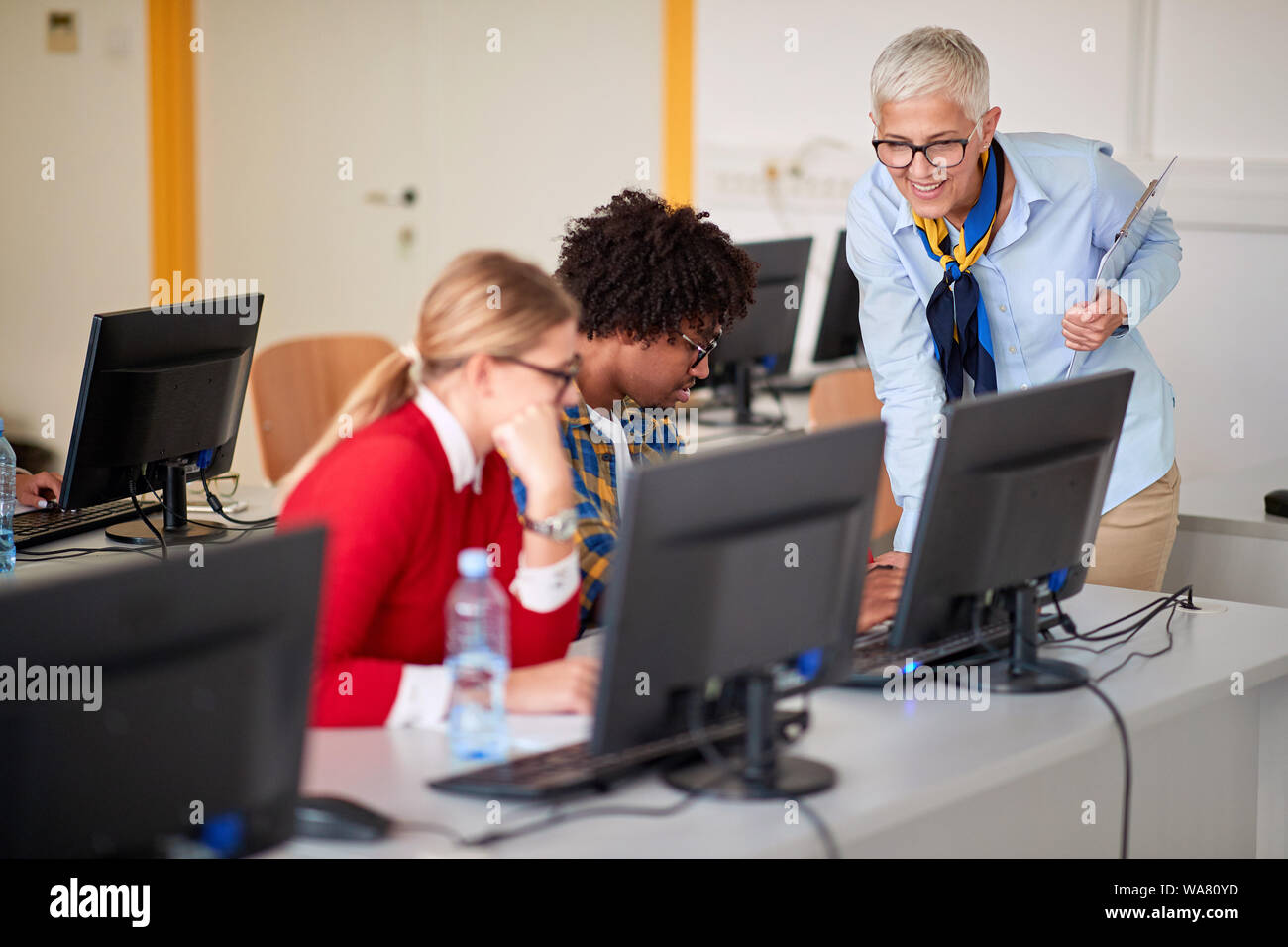 class with young students on computer on university campus Stock Photo ...
