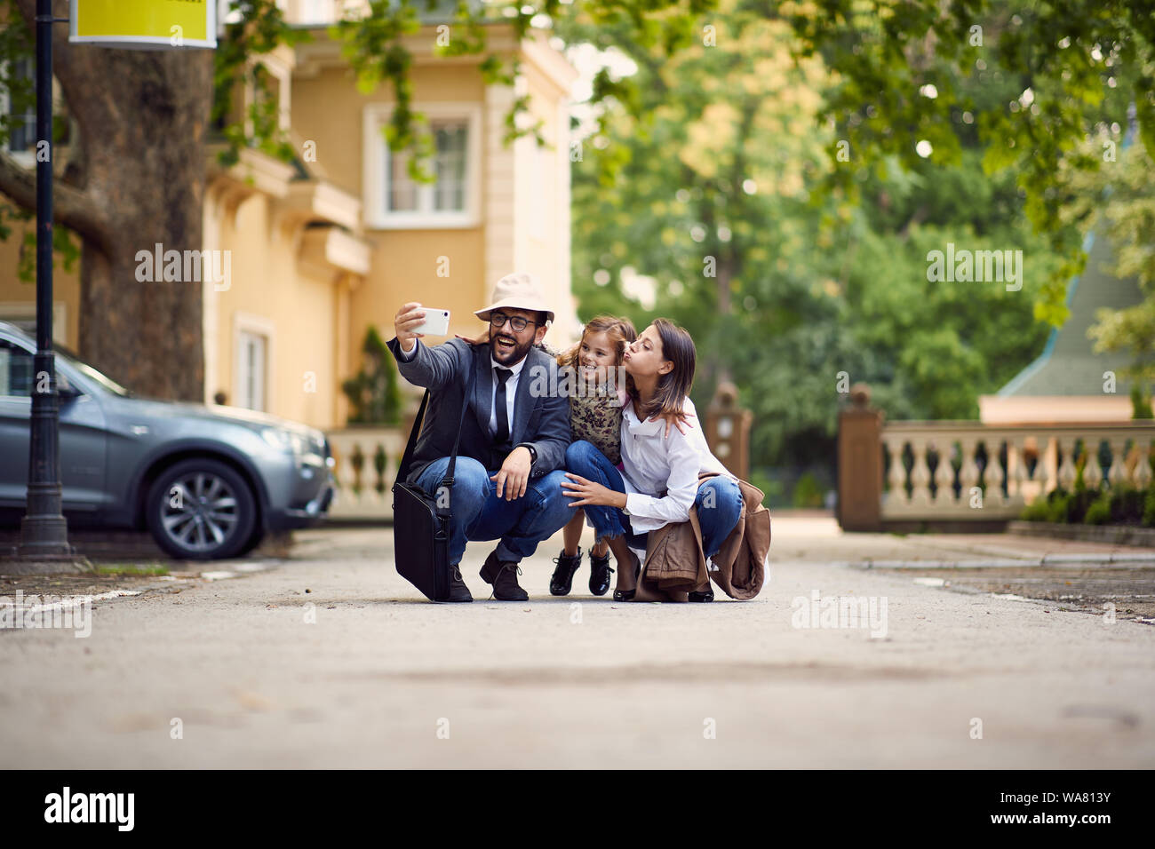 silly family photo in front of school Stock Photo - Alamy