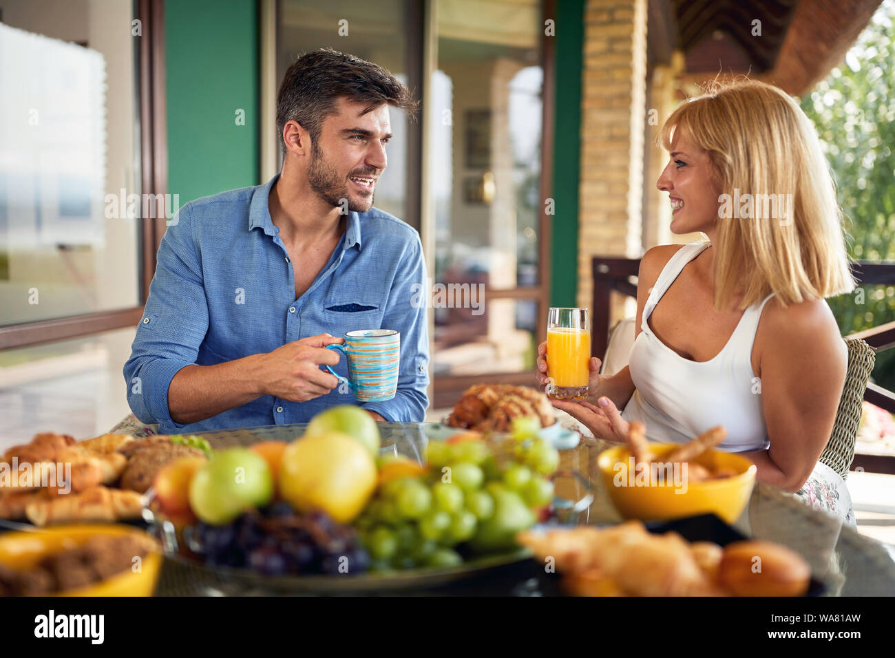 Lovely young couple having breakfast together Stock Photo - Alamy