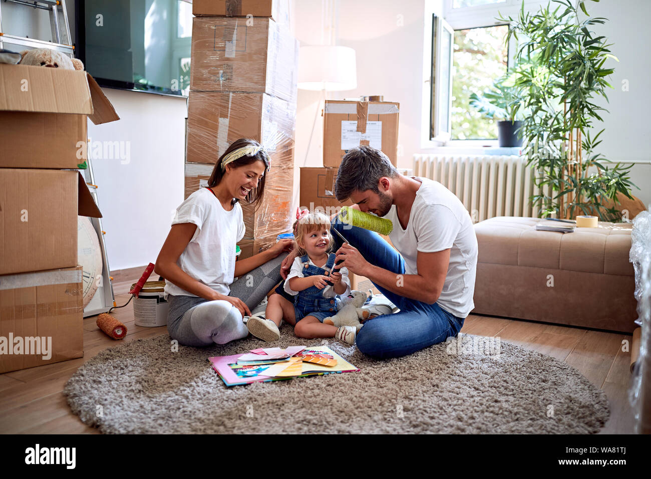 Happy loving family in new home Stock Photo - Alamy