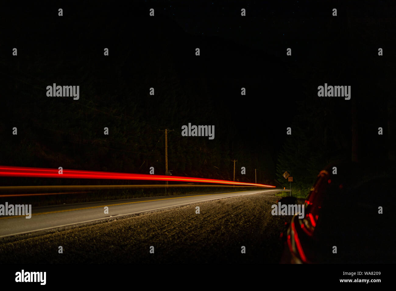 Long exposure of car lights on rural highway at night Stock Photo - Alamy