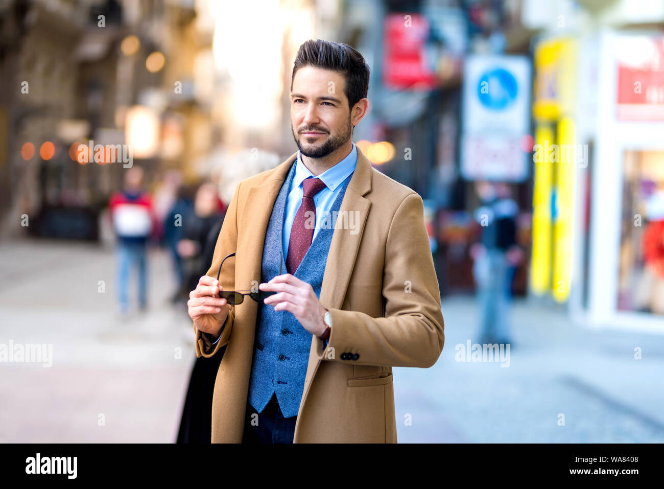 A handsome elegant man walking on the streets on a sunny day Stock ...