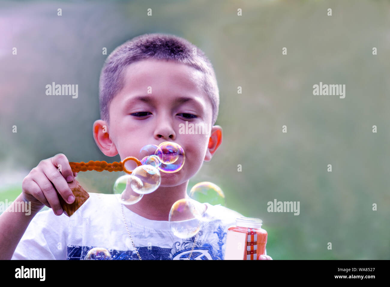 Child discovering the magic of bubbles Stock Photo - Alamy