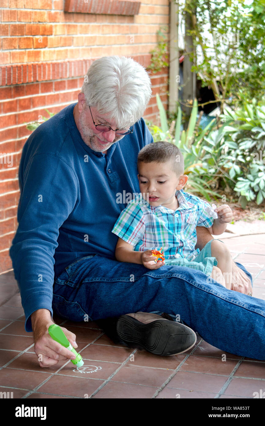 child drawing with grandpa using sidewalk chalk Stock Photo - Alamy