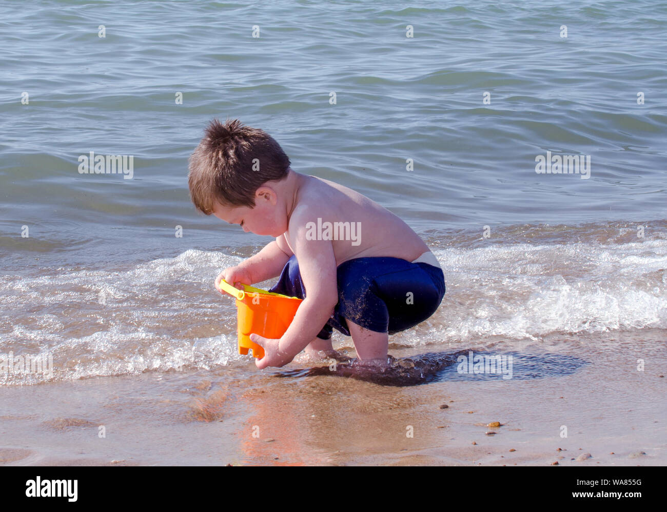 Filling a bucket with sand hi-res stock photography and images - Alamy
