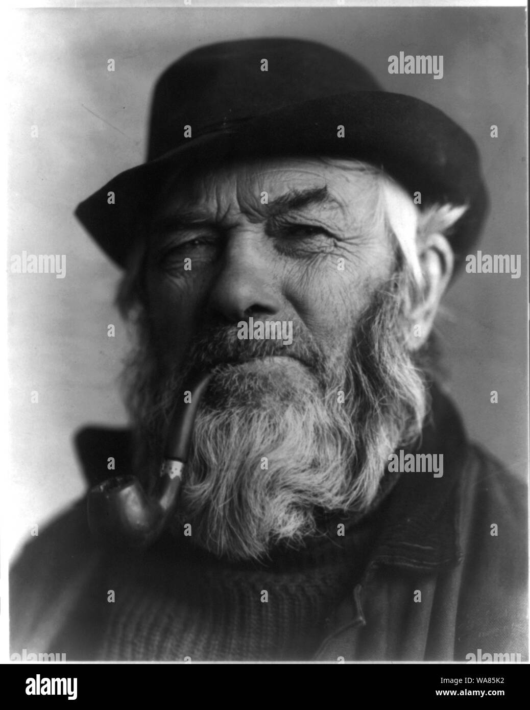 Bust portrait of bearded man with pipe facing front Stock Photo - Alamy
