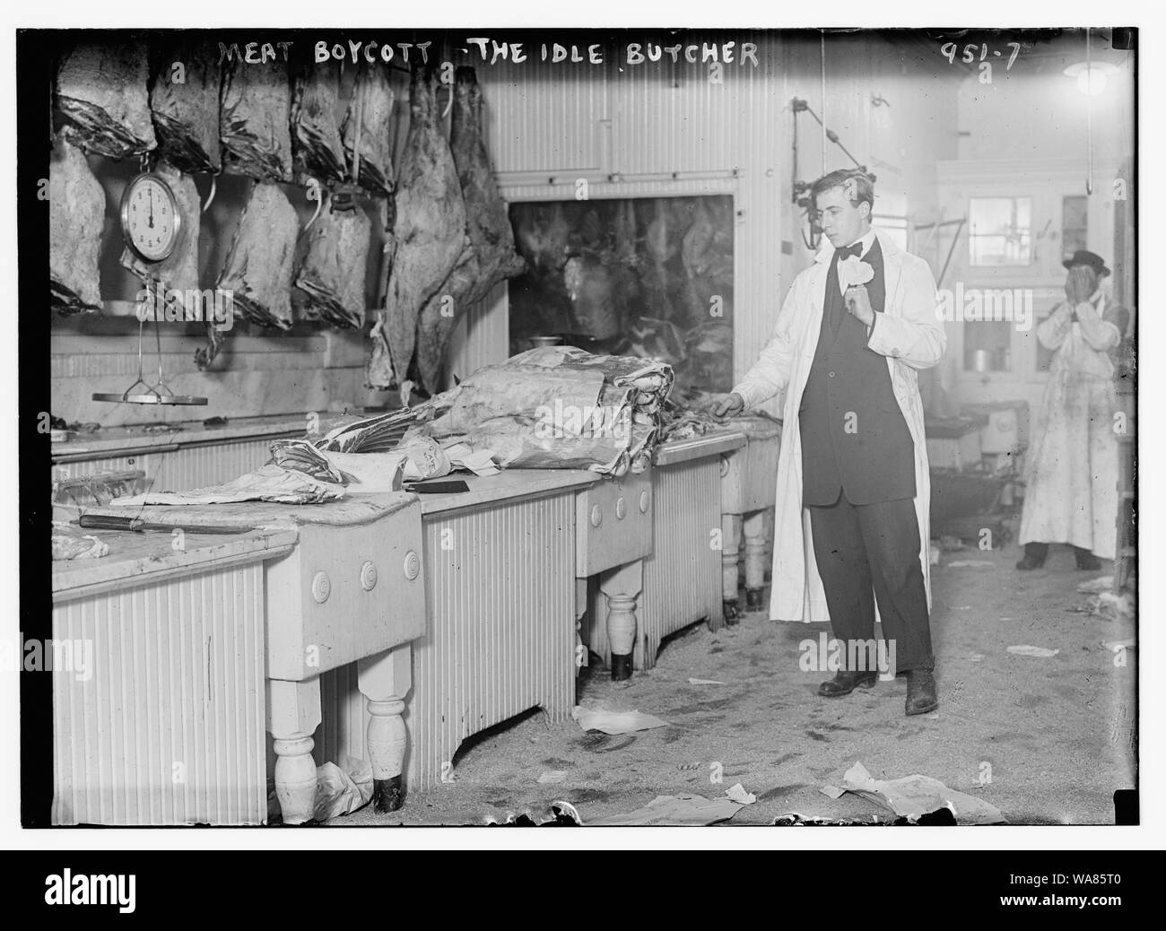 Butcher stands idle before his counter of meat during the meat boycott ...