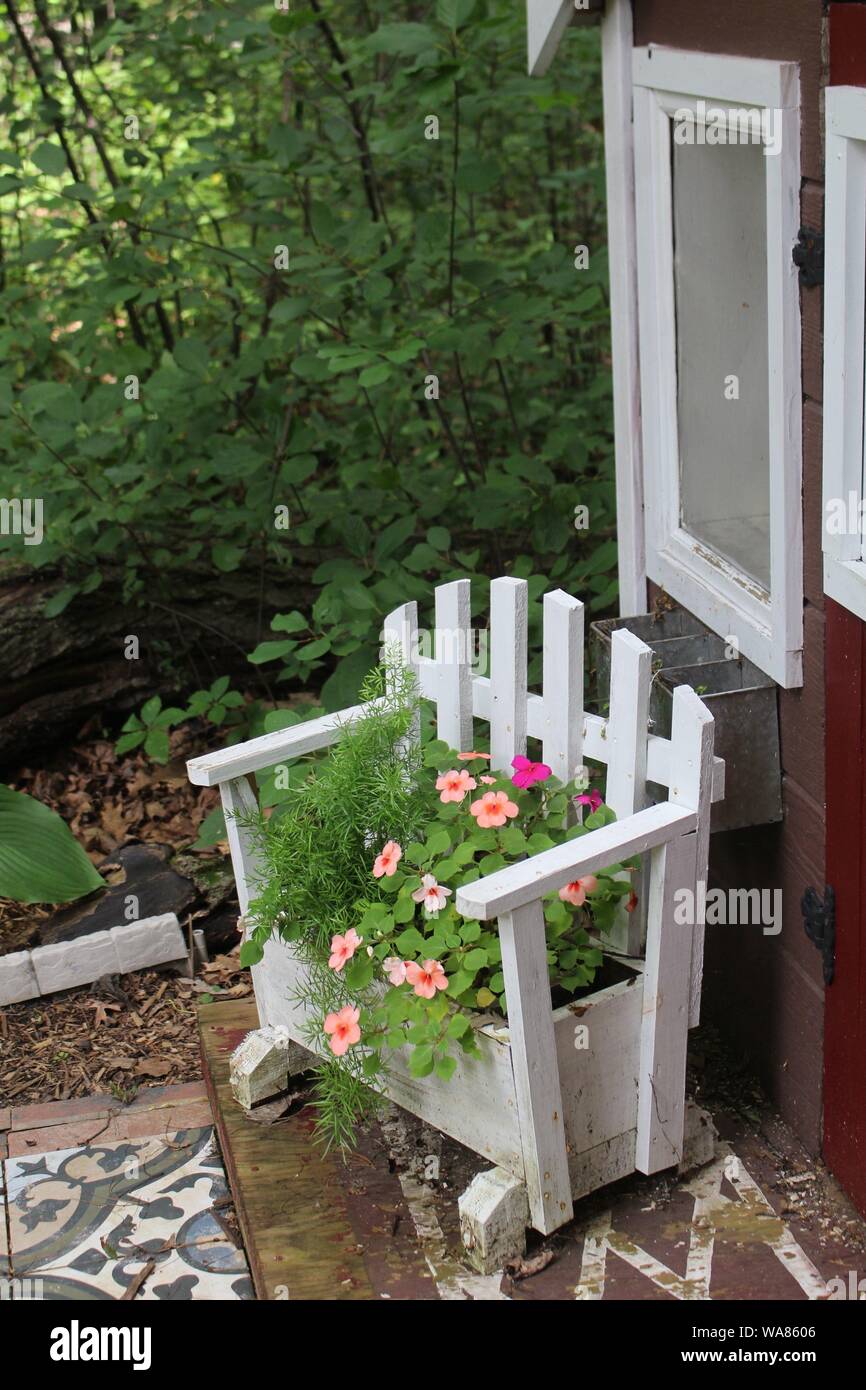 Rustic bench with flowers Stock Photo - Alamy