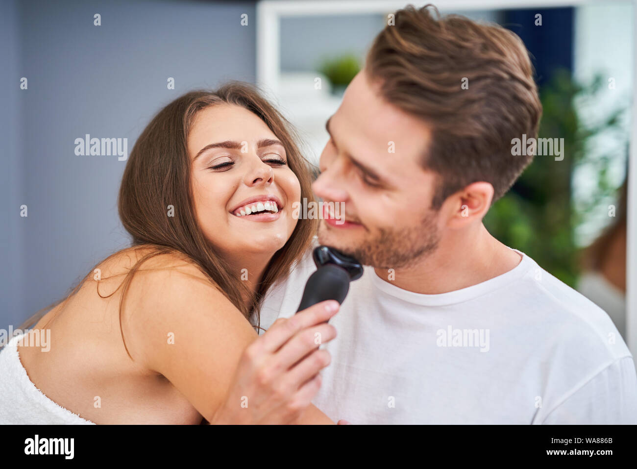 Portrait of happy young couple in the bathroom Stock Photo - Alamy
