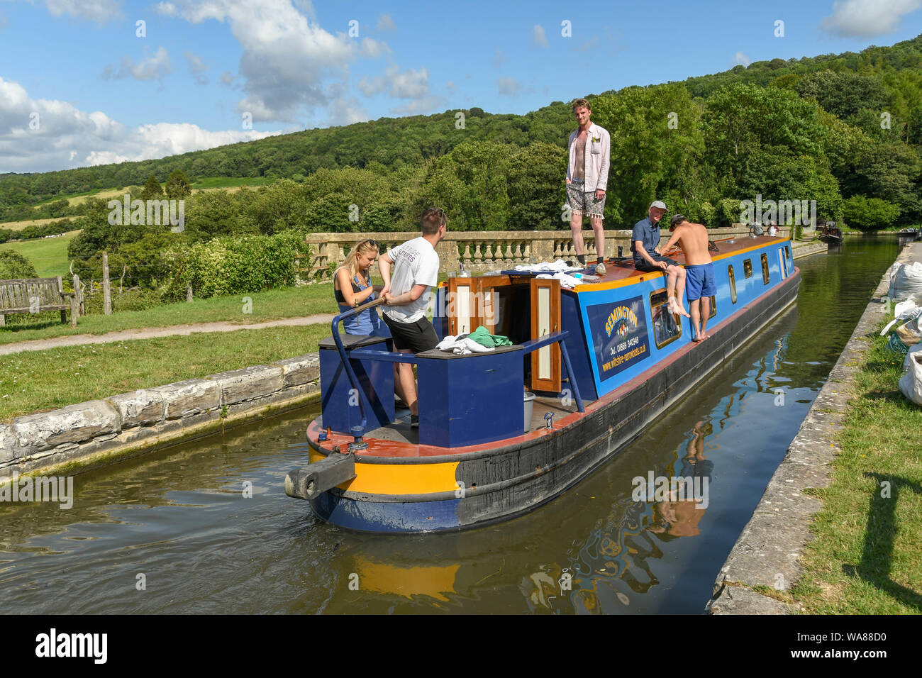 BATH, ENGLAND - JULY 2019: Narrow boat with people on board sailing ...