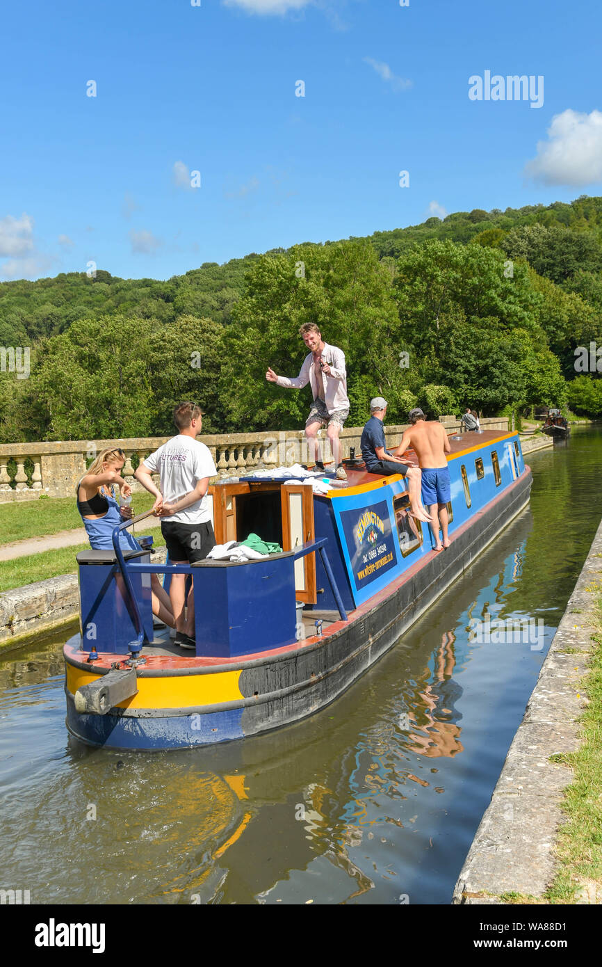 BATH, ENGLAND - JULY 2019: Narrow boat with people on board sailing ...