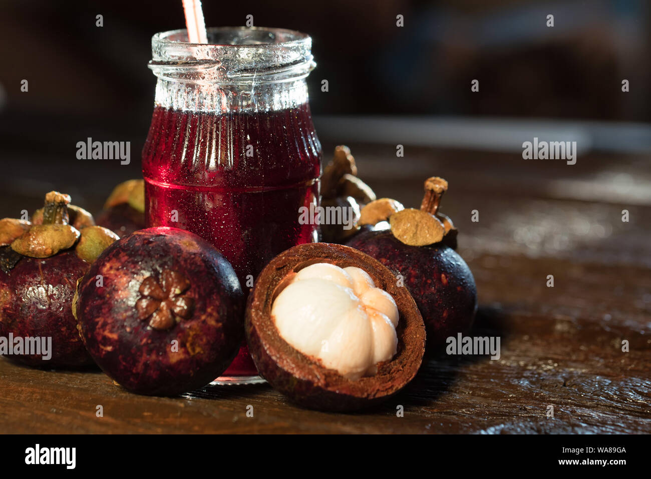 Close up mangosteen fruit and drink on wooden background. Selective ...