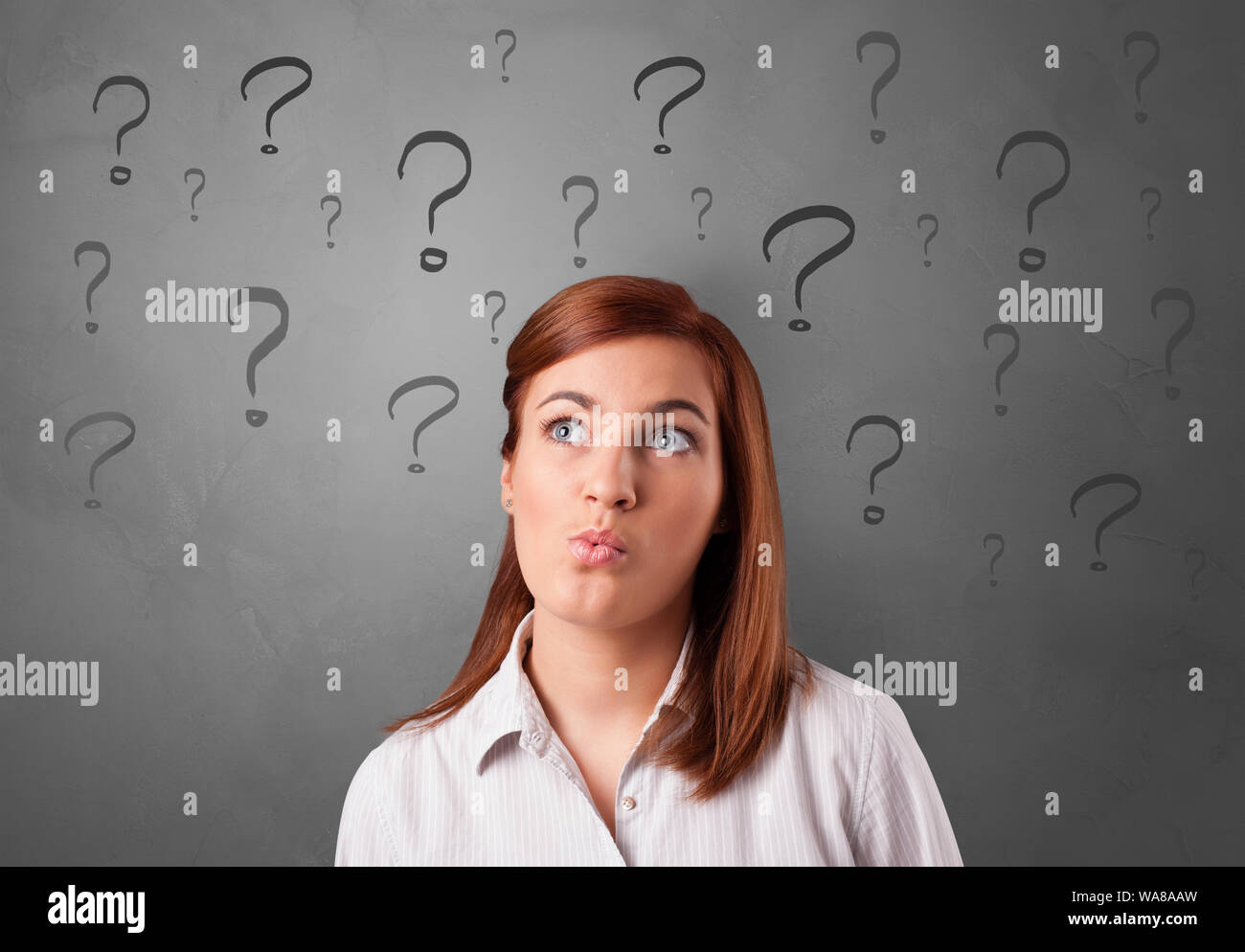 Person with question marks around face Stock Photo - Alamy