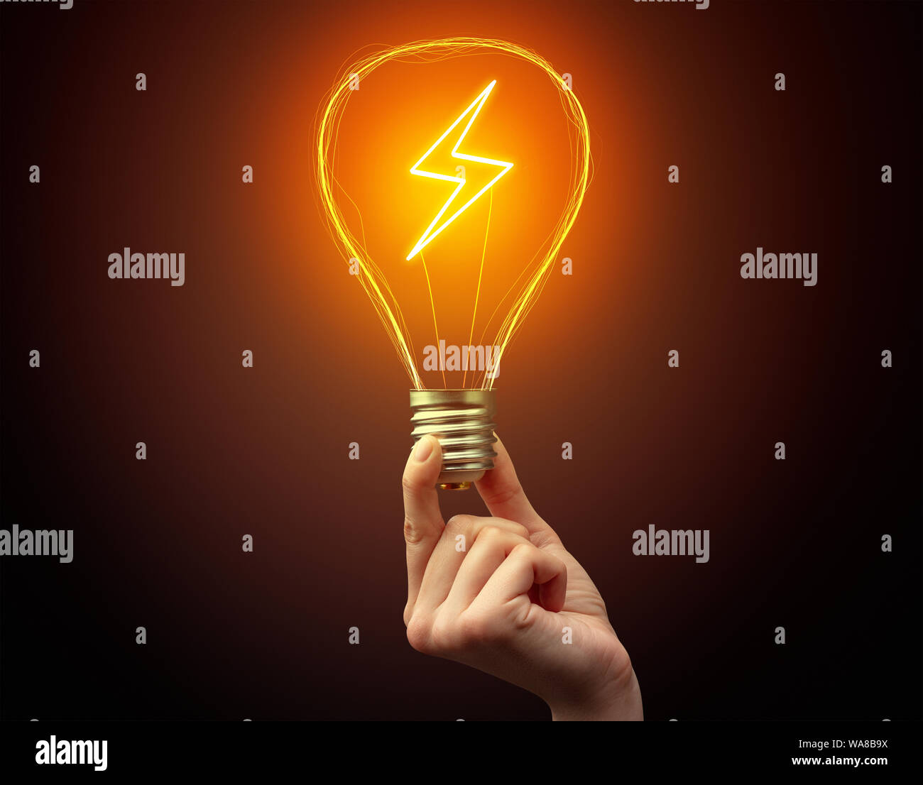 Hand holding light bulb on dark background. New Eco idea concept Stock ...