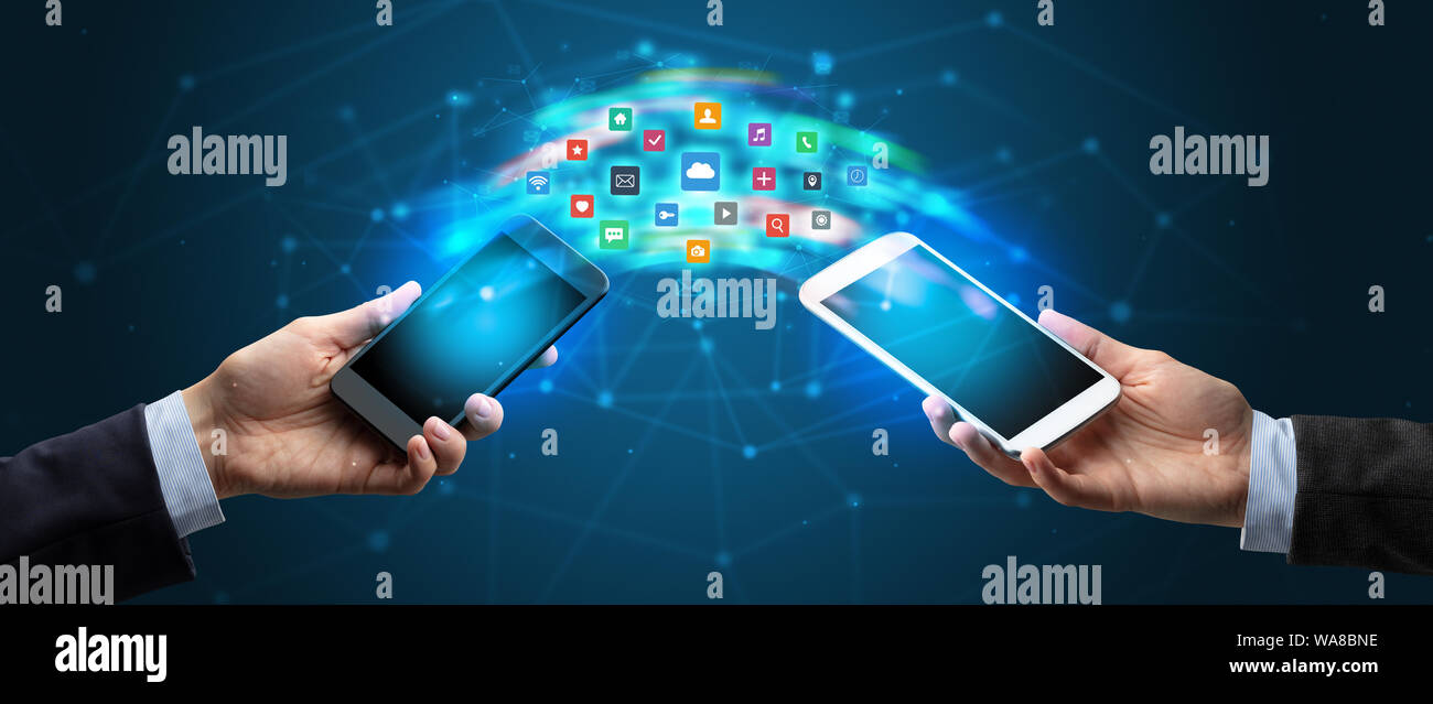 Two mobile phones syncing applications concept Stock Photo - Alamy