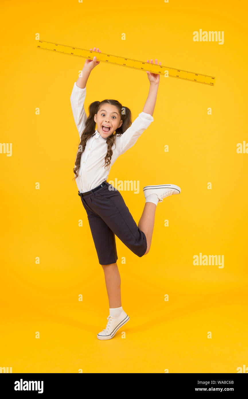 Exploring stem. Sizing and measuring. Pupil cute girl with big ruler ...