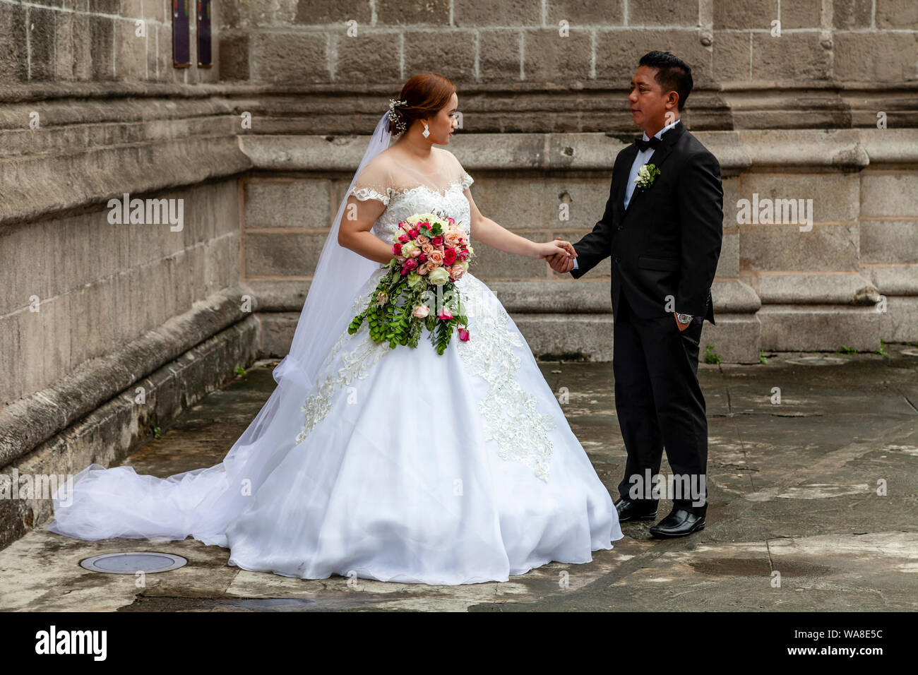 A Filipino Couple Pose For Wedding Photos Outside A Church In ...